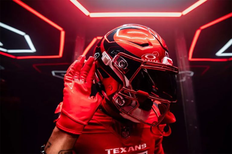 The red jersey notably displays a white “Texans” wordmark above the ...