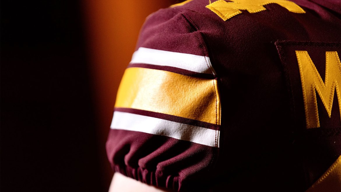 The look is complete with matching maroon, gold and white pants, though ...