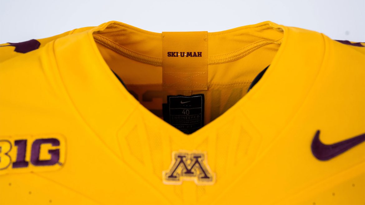 The look is complete with matching maroon, gold and white pants, though ...